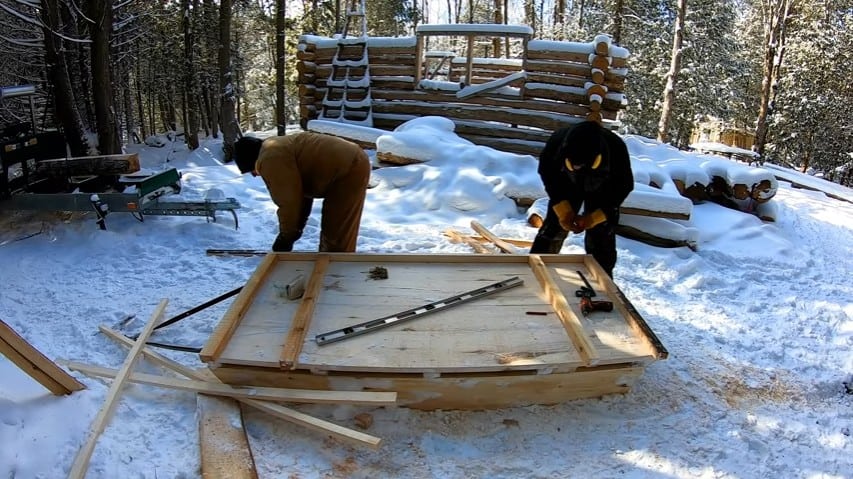 Two men build cozy snowmobile camper from scratch