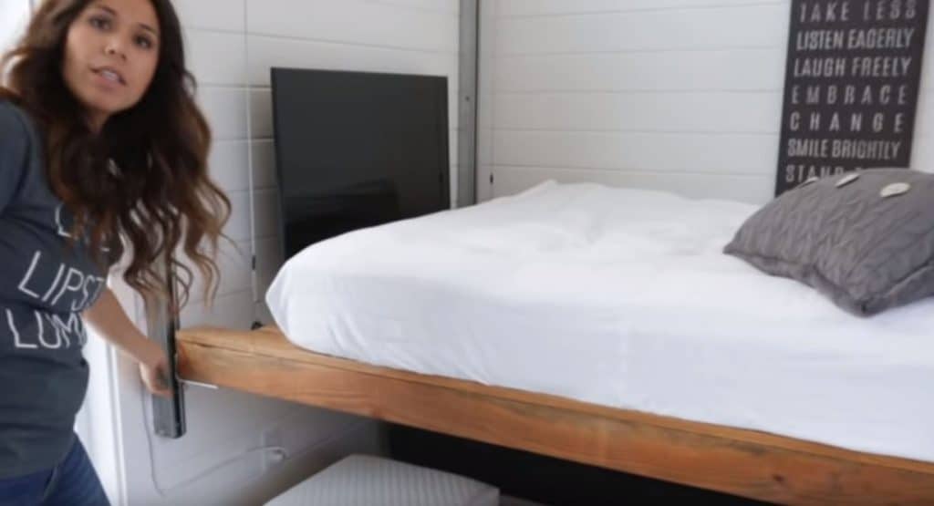 Open-concept modern tiny house customized with an elevator bed