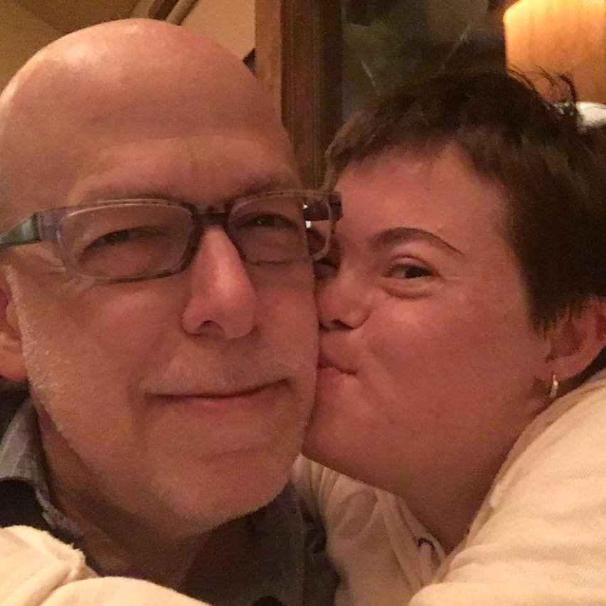 Proud dad beams as daughter with Down syndrome graduates