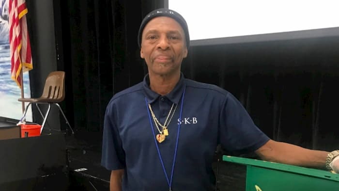 School employees and parents surprise janitor who walks every day to ...