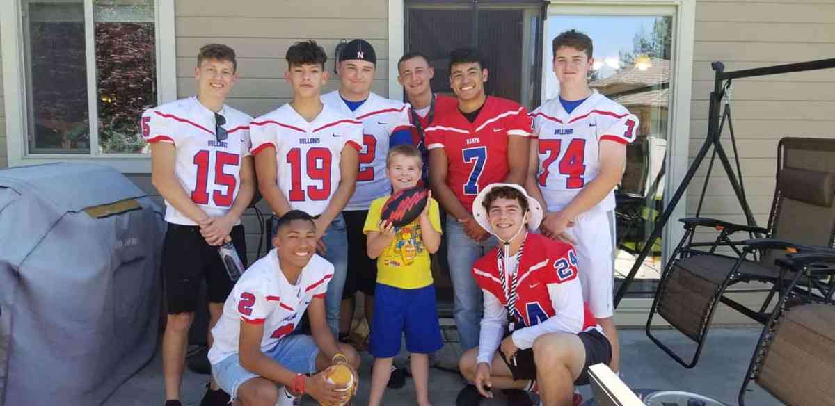Teen football players show up to celebrate autistic boy's birthday