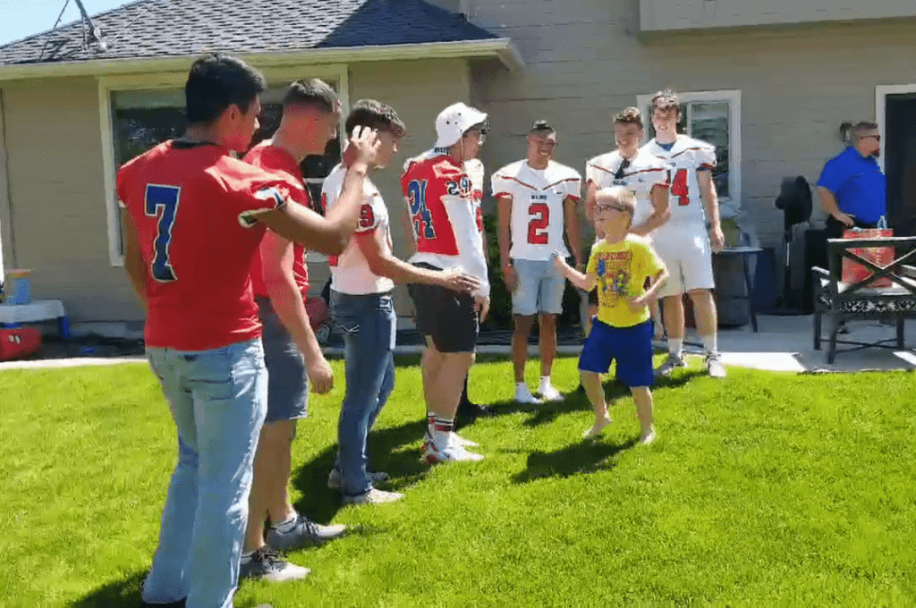 Teen football players show up to celebrate autistic boy's birthday